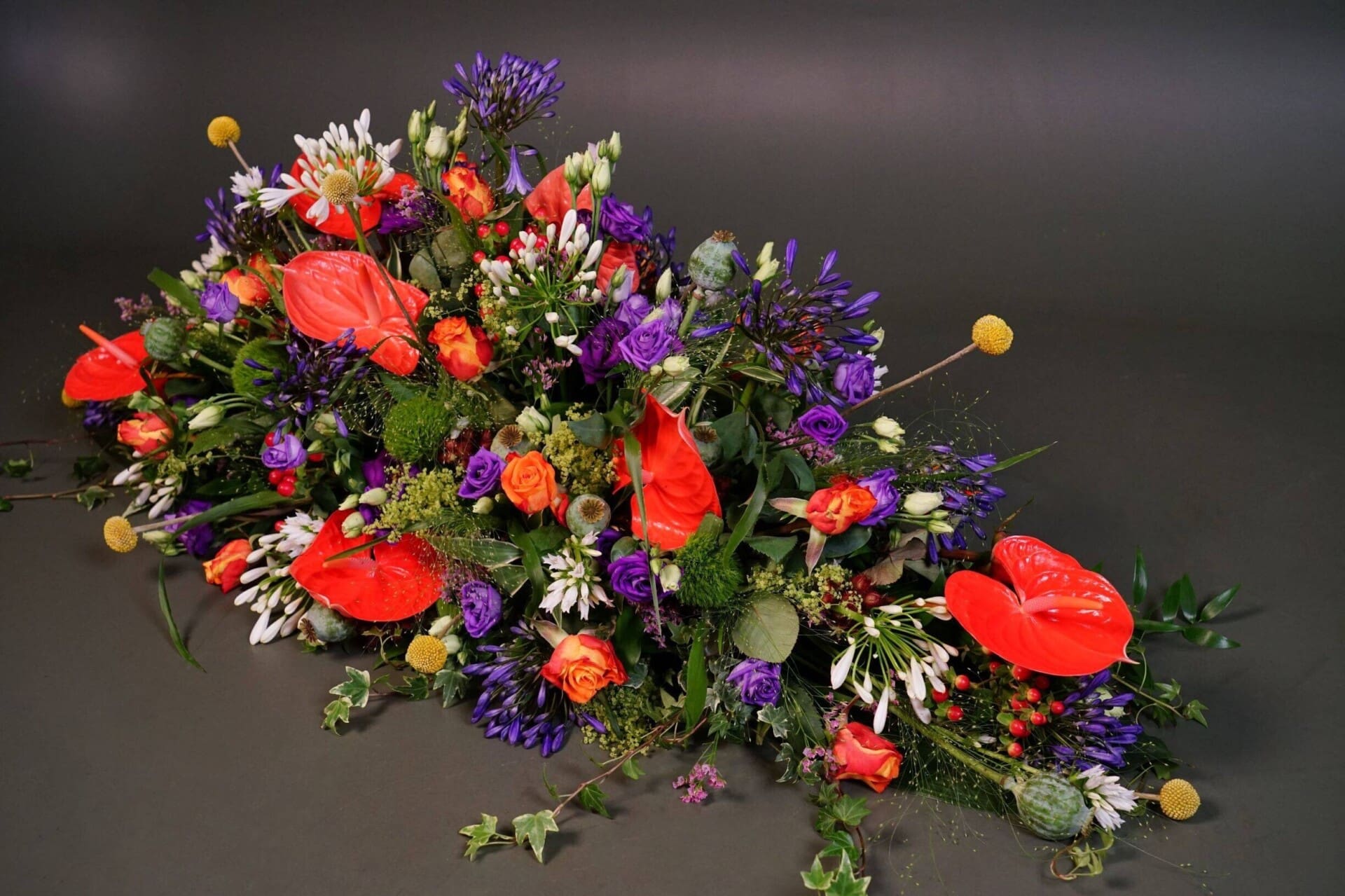 Veldachtig bloemrijk kist arrangement. Bont, bloomon stijl bloemstuk